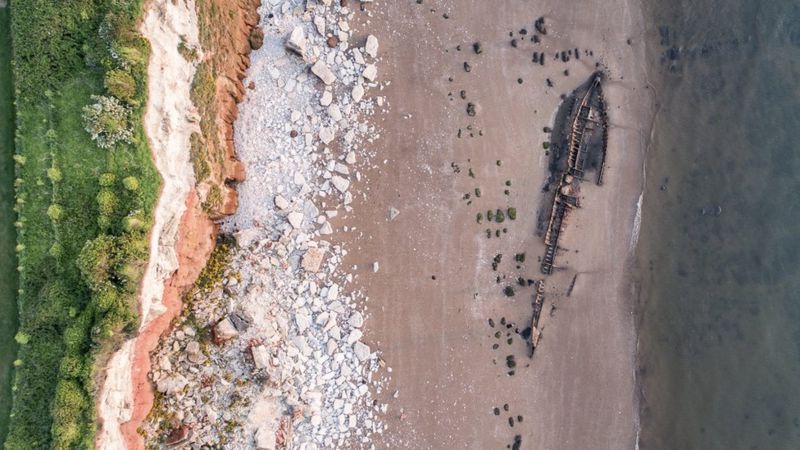 Photos show impact of time on Norfolk beach wreck - BBC News
