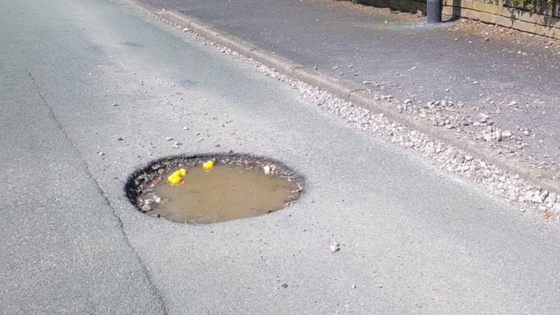 Floating rubber ducks added to flooded pothole in Staffordshire - BBC News