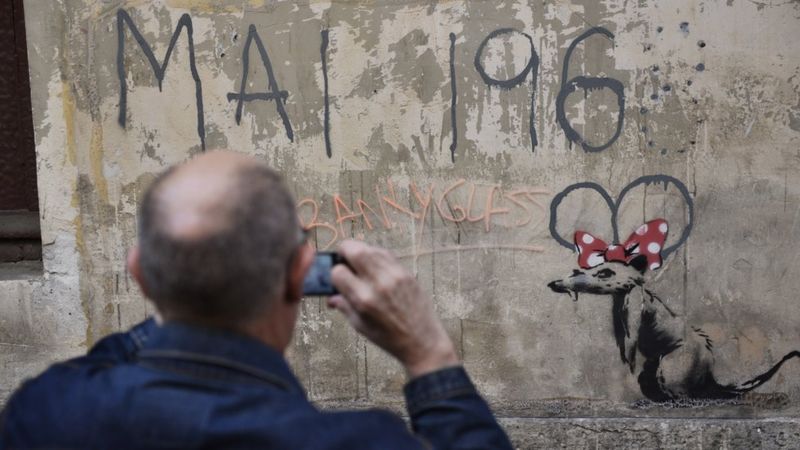 In pictures: Banksy hits Paris streets for first time - BBC News