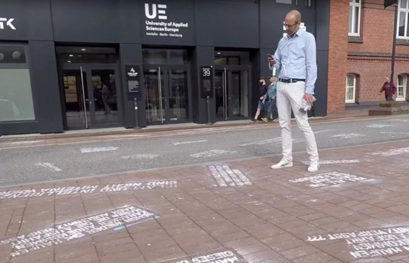 'Hate speech' tweets painted at Twitter HQ in protest - BBC News