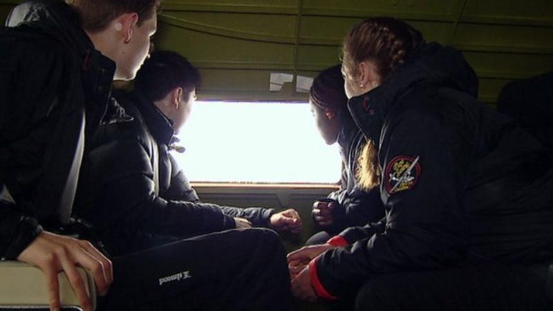 Arctic expedition pupils flying in a boat in the sky - BBC News