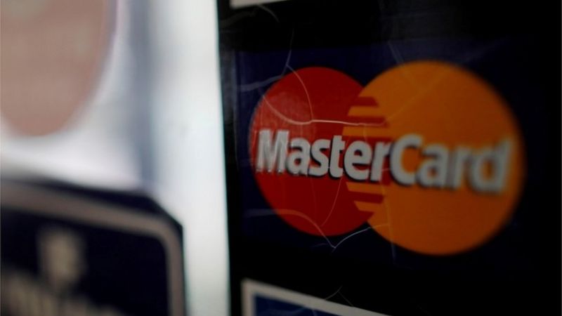 Mastercard and Visa agree to cut overseas card fees - BBC News