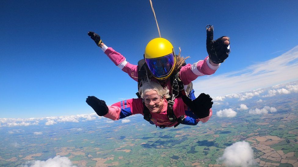 Stone woman with fear of heights does charity skydive - BBC News