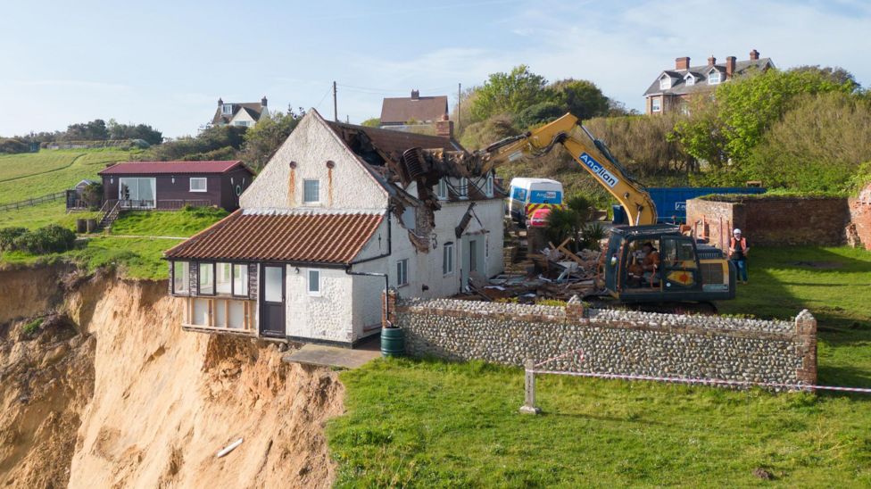 Trimingham farmhouse teetering over cliff edge demolished - BBC News