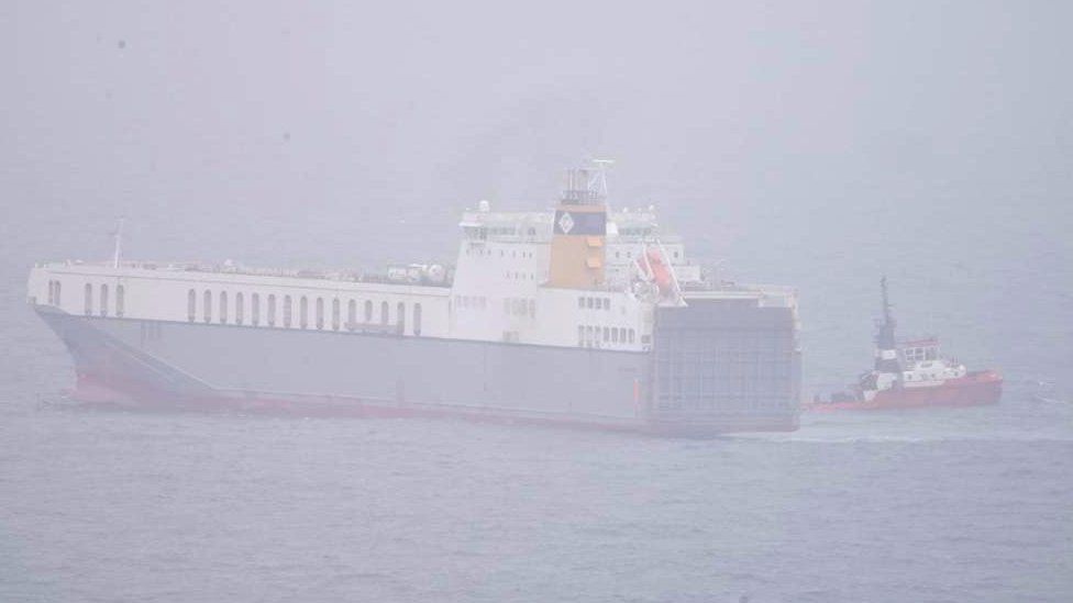 Cargo ship towed to safety after grounding near lighthouse - BBC News
