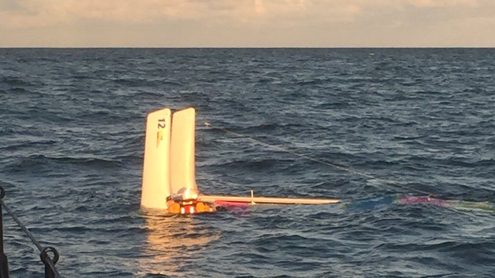 Coastguard search for skipper of upturned catamaran - BBC News