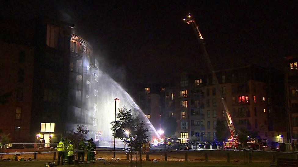 Clapton flats fire: Woman rescued during 'suspicious' blaze - BBC News
