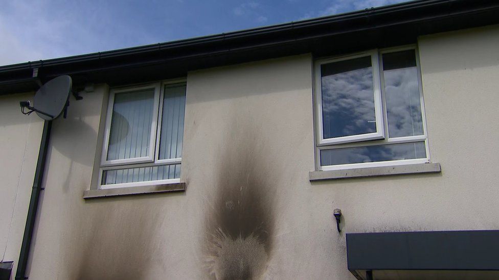 Coleraine: Woman slept in living room as petrol bomb hit window - BBC News