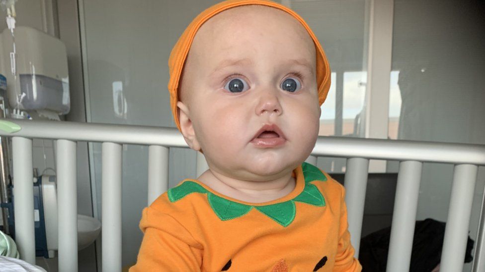 Pub regulars don hats for baby Esmai's brain tumour fundraiser - BBC News