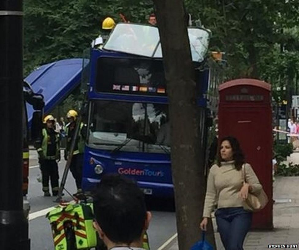 Four injured after roof is ripped off London tour bus - BBC News