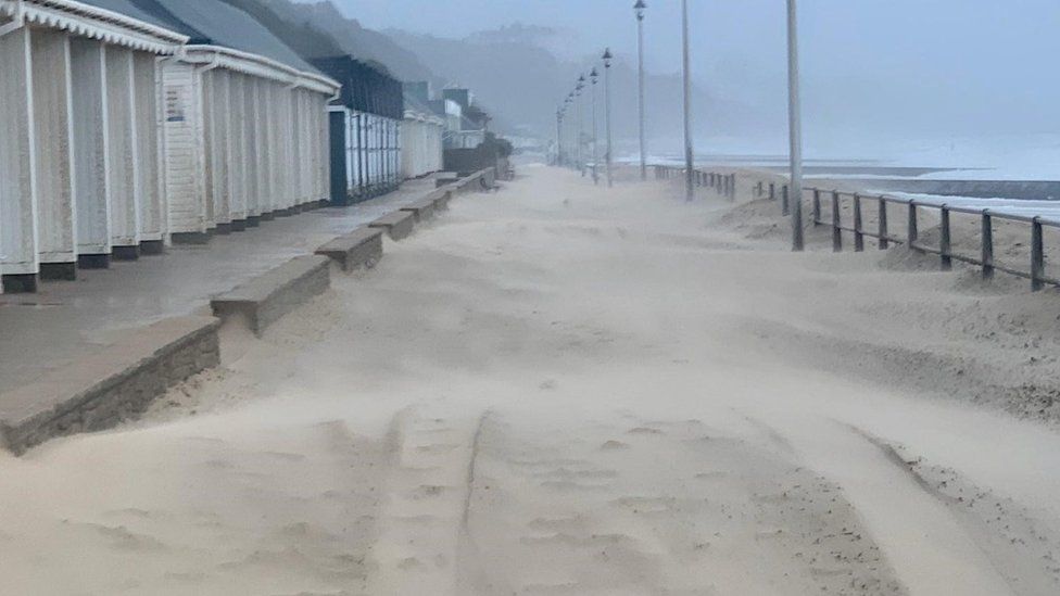 Storm Ciara: Deep sand drifts left on Bournemouth promenade - BBC News