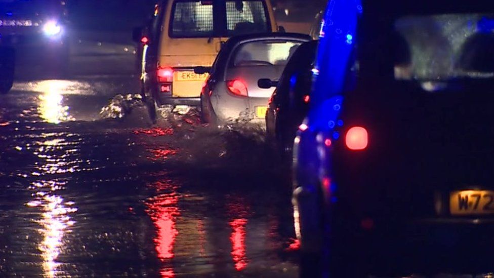 Firefighters rescue passengers from flood-struck cars overnight - BBC News