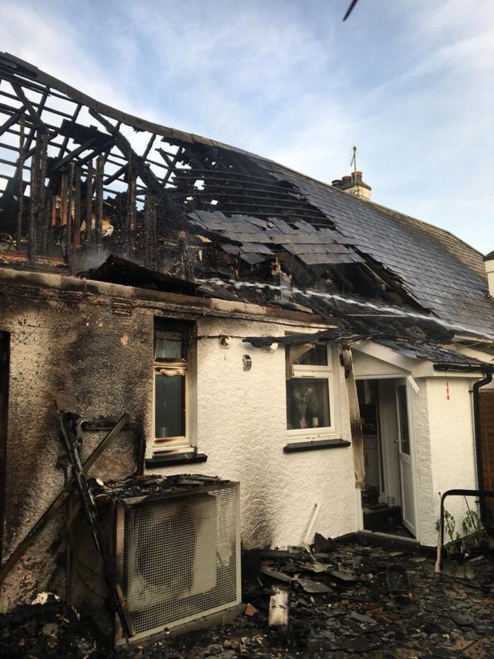 Family moves back home two years after fire - BBC News