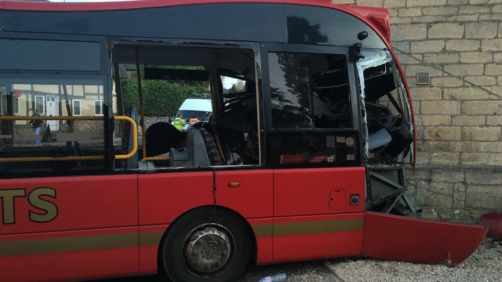 Four people hurt as bus crashes into house in Prestbury - BBC News