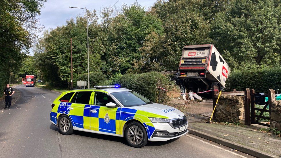 Woman hurt as Müller milk lorry crashes into garden in Brinsley - BBC News