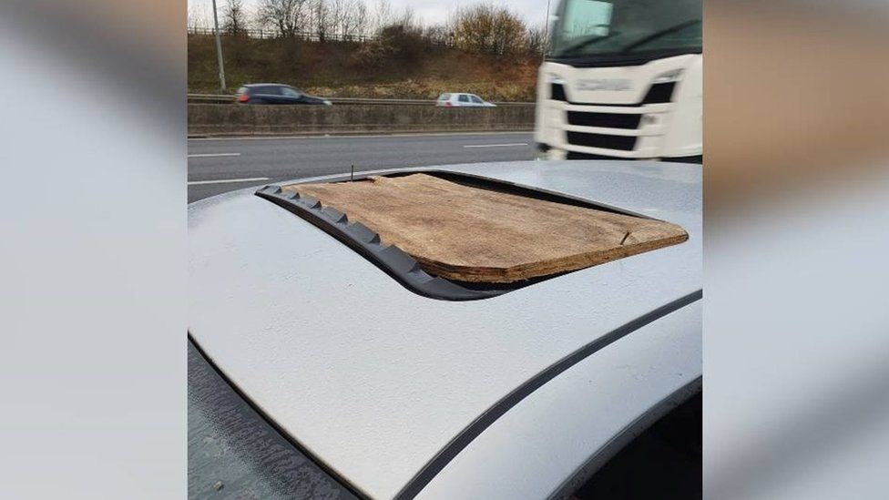 Car driven with wooden plank nailed to sunroof on M25 in Hertfordshire ...