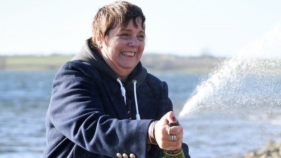 Lottery winner buys lawnmower after scooping £1m - BBC News