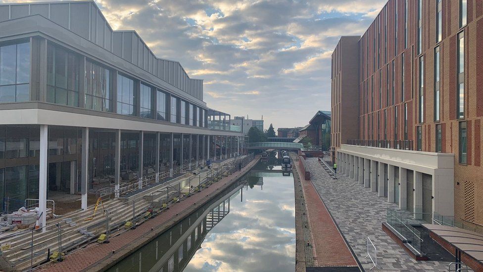 Council-owned Castle Quay development value falls by 40% - BBC News