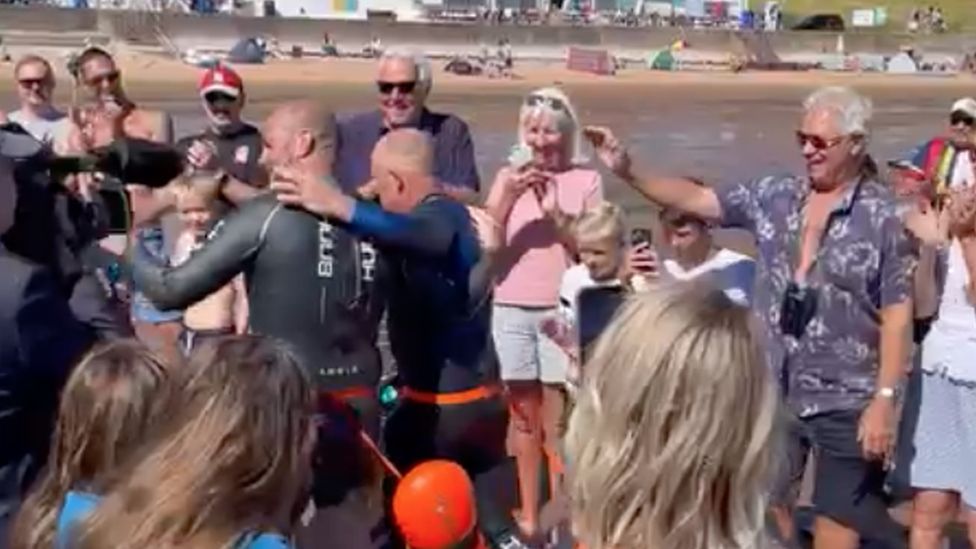 Devon: Ex-marine finishes 'brutal' 30-mile overnight swim - BBC News