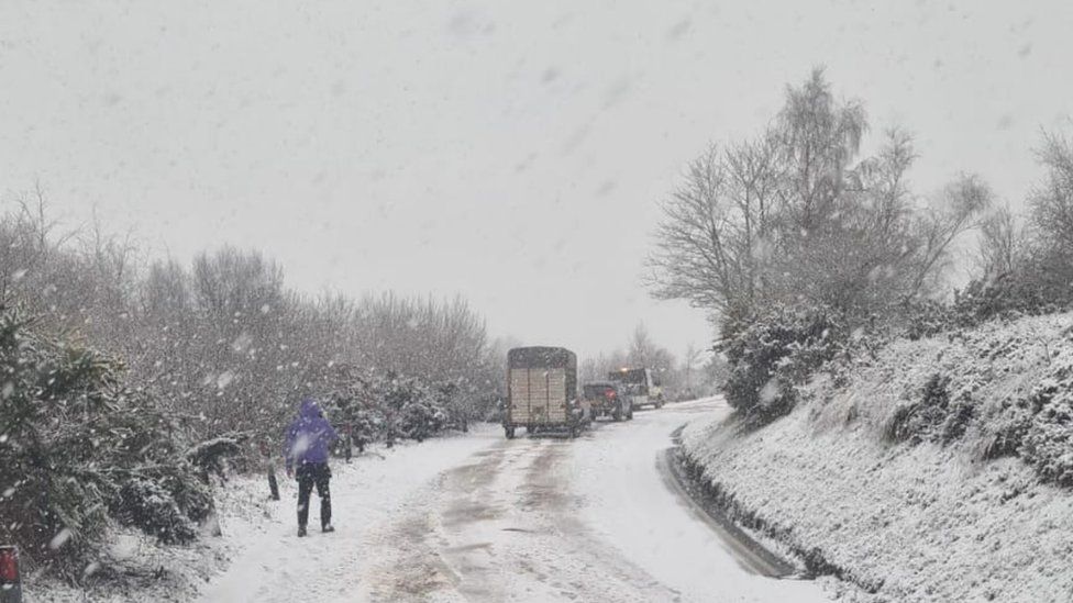 Wintery Devon roads lead to collisions and stuck cars - BBC News