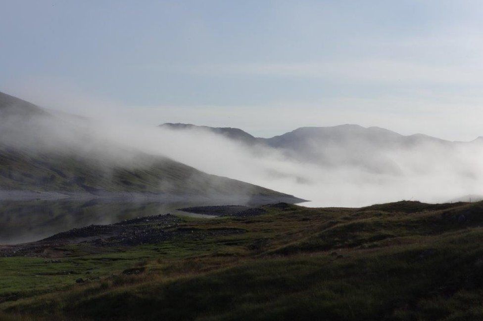 Drowned landscape revealed after levels drop at loch - BBC News