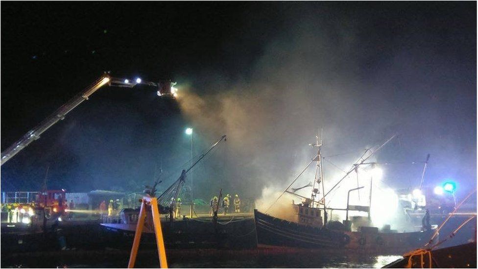 Firefighters tackle Peel fishing boat blaze - BBC News