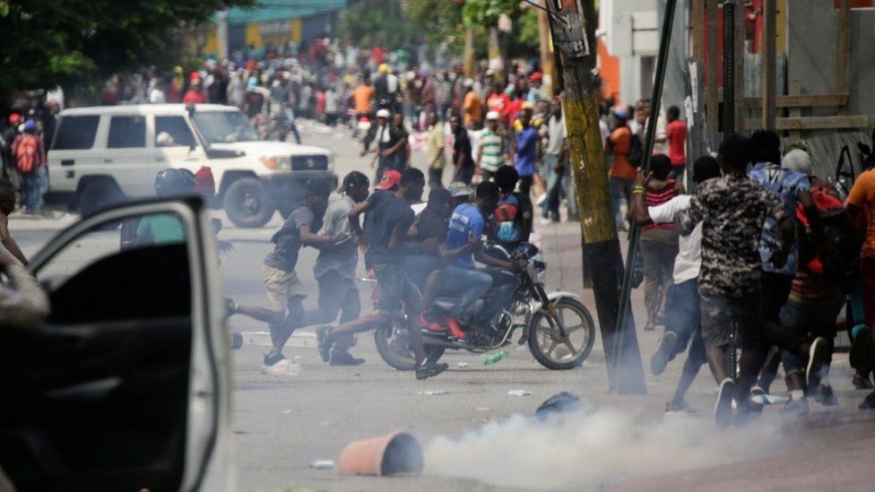 Haiti unrest: Shops and police station looted as thousands protest ...