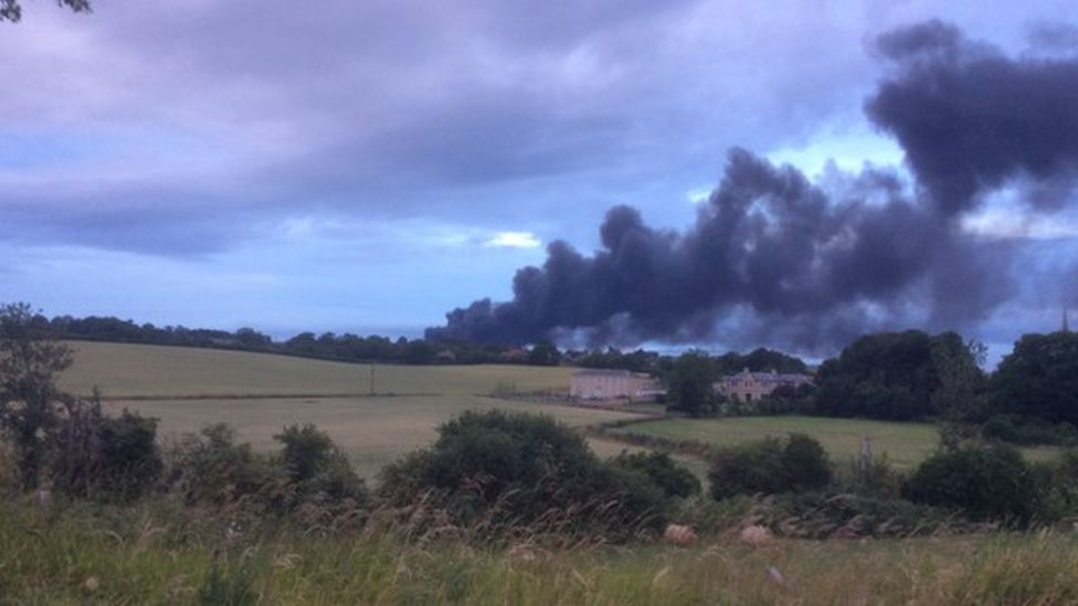Staff help fire crews with Ancaster recycling fire clean-up - BBC News