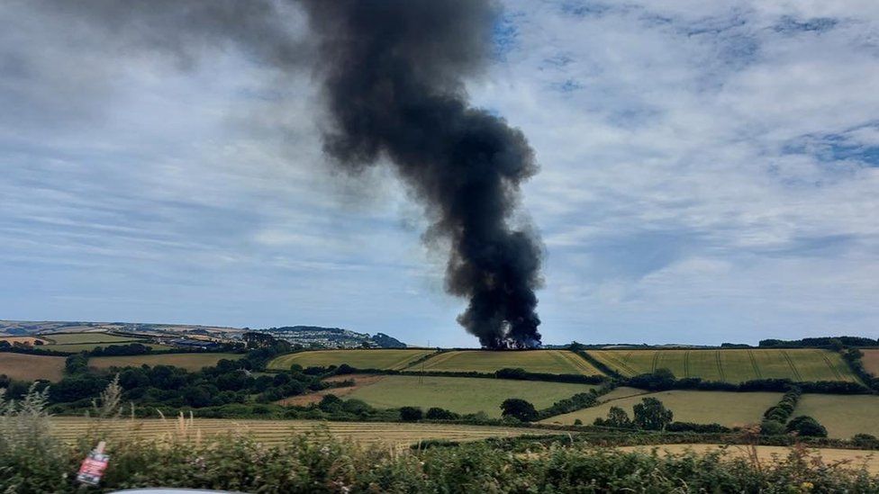 Tractor fire closes road in Devon - BBC News