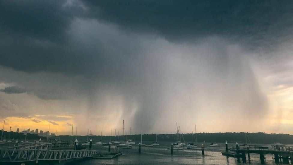 Sydney storms light up city after record heat - BBC News