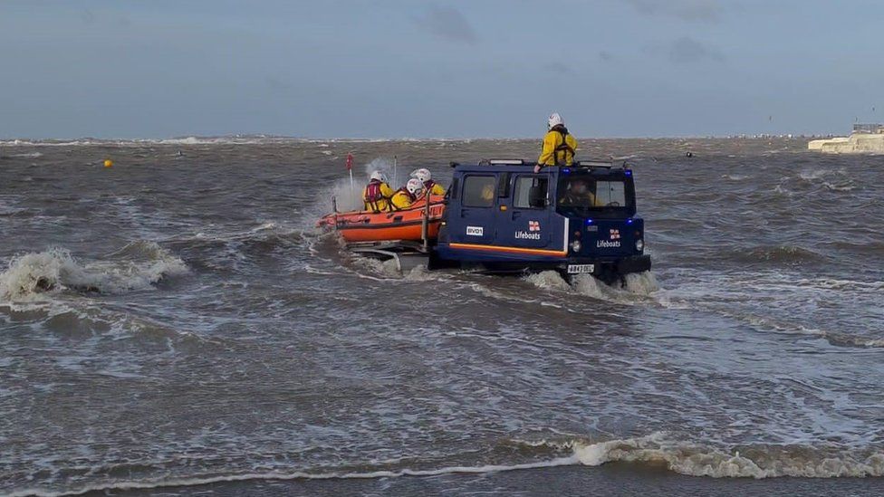 West Kirby: Windsurfer rescued in strong winds and high tides - BBC News