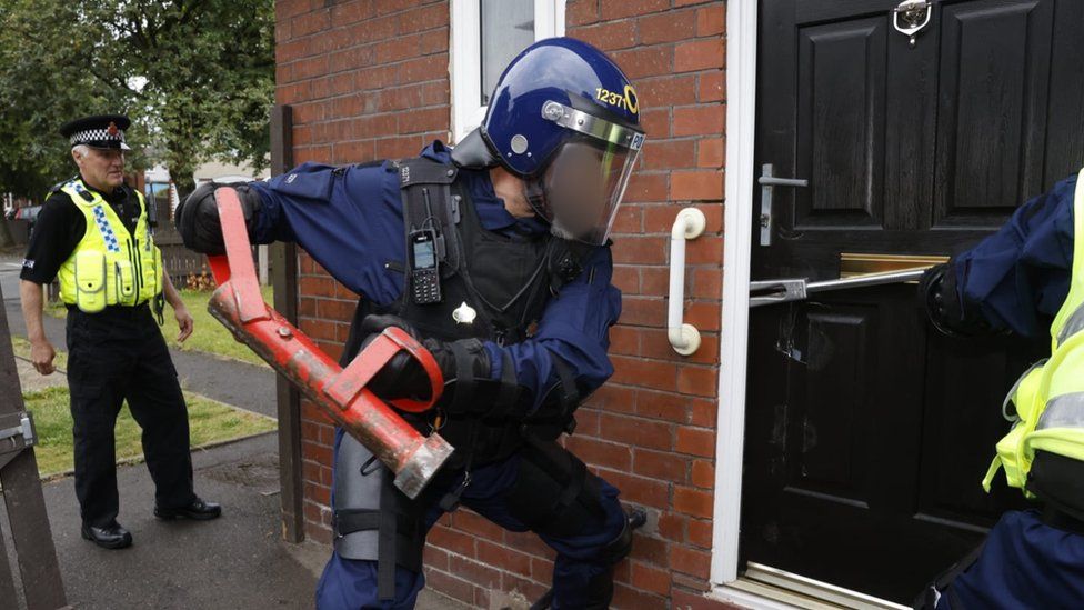 Wigan raids: Police arrest 56 people and seize guns - BBC News