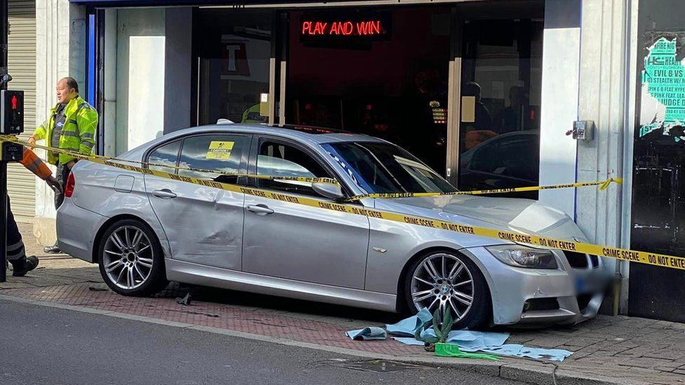 Three arrested after car hits Kingswood shop front - BBC News
