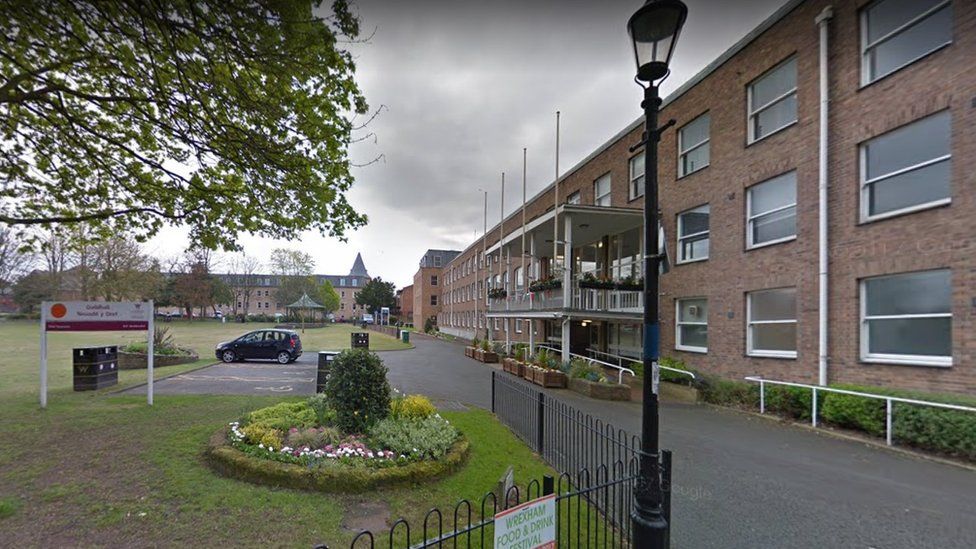 Wrexham council backs budget despite protests over cuts - BBC News