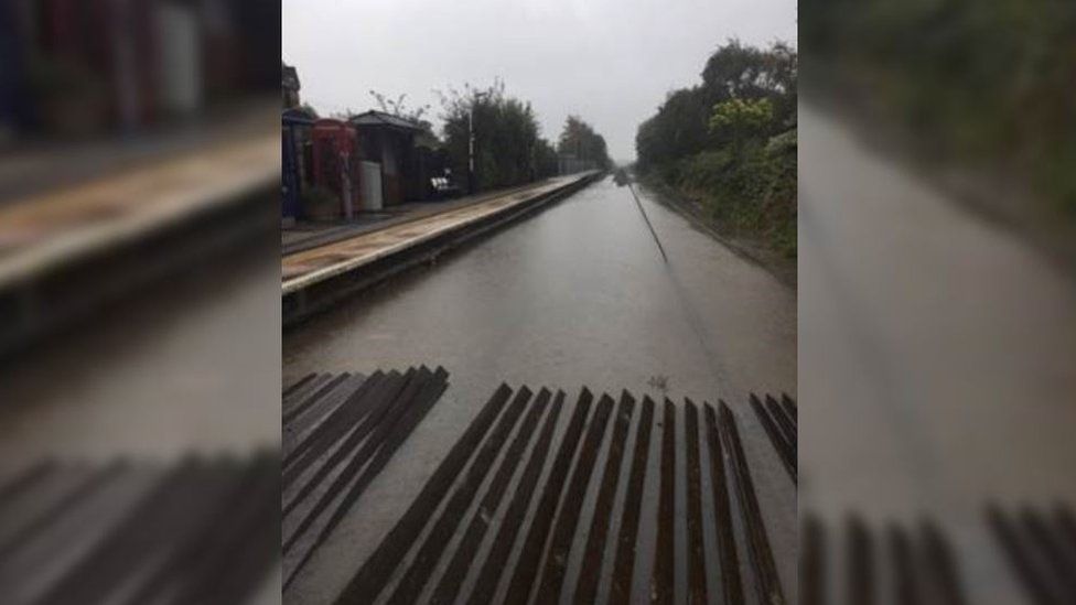 Flooded tracks cause rail travel disruption - BBC News