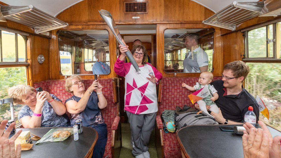 Baton rides steam train as West Midlands relay leg continues - BBC News