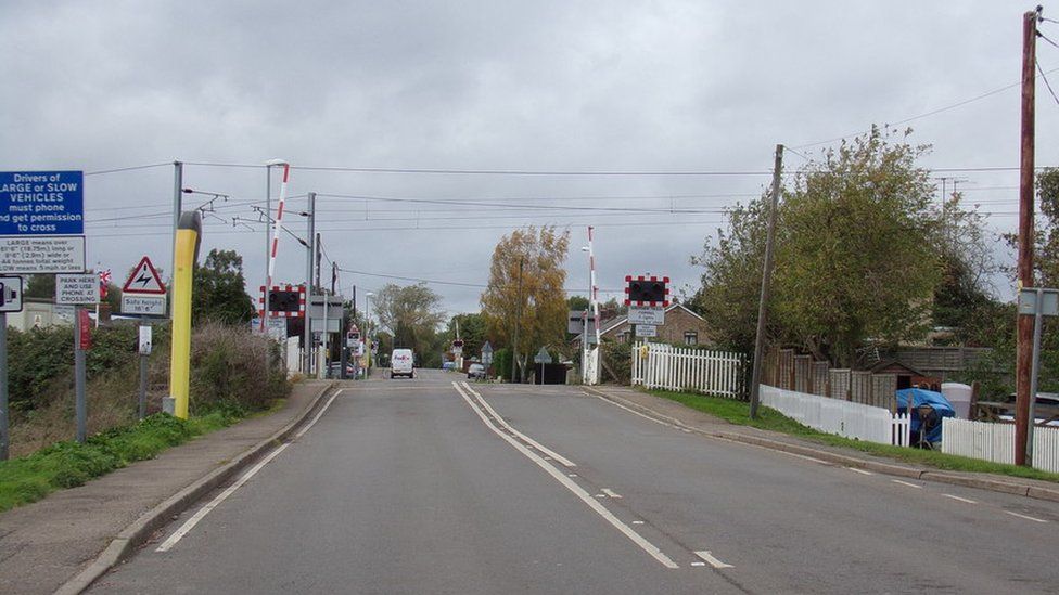 Trains delayed after cyclist skids at level crossing near Ely - BBC News