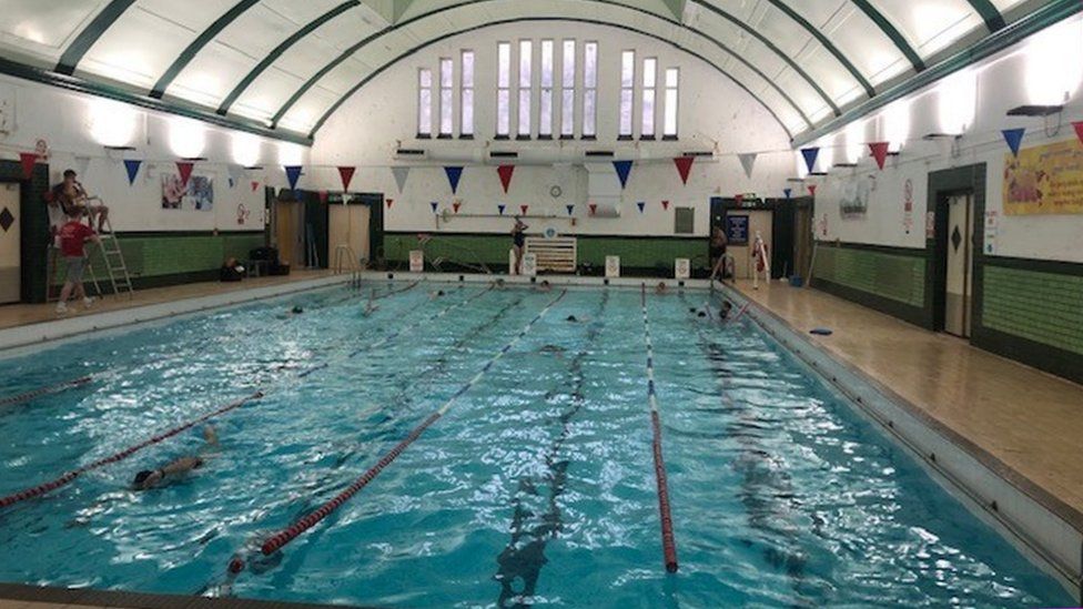 Swimmers 24-hour swimathon to raise pools fuel funds - BBC News