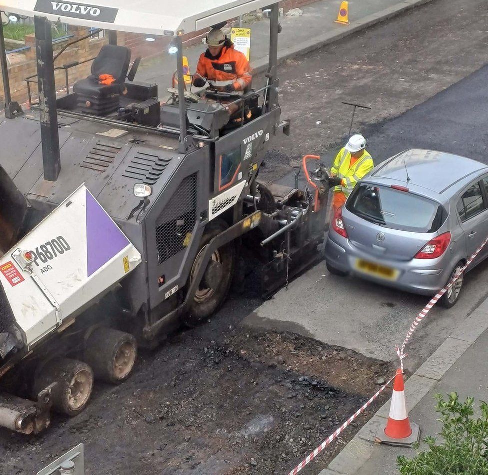 Scarborough road resurfaced around parked car - BBC News