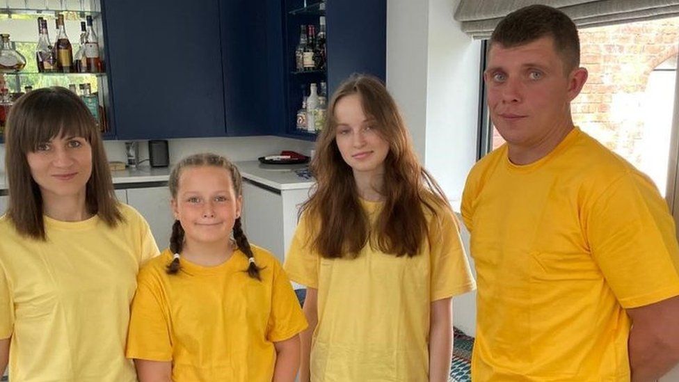 Ukraine family get their own home after sharing for months - BBC News