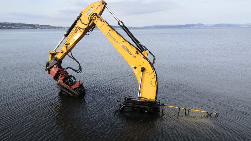 Mumbles: Digger left on beach swamped by high tide - BBC News