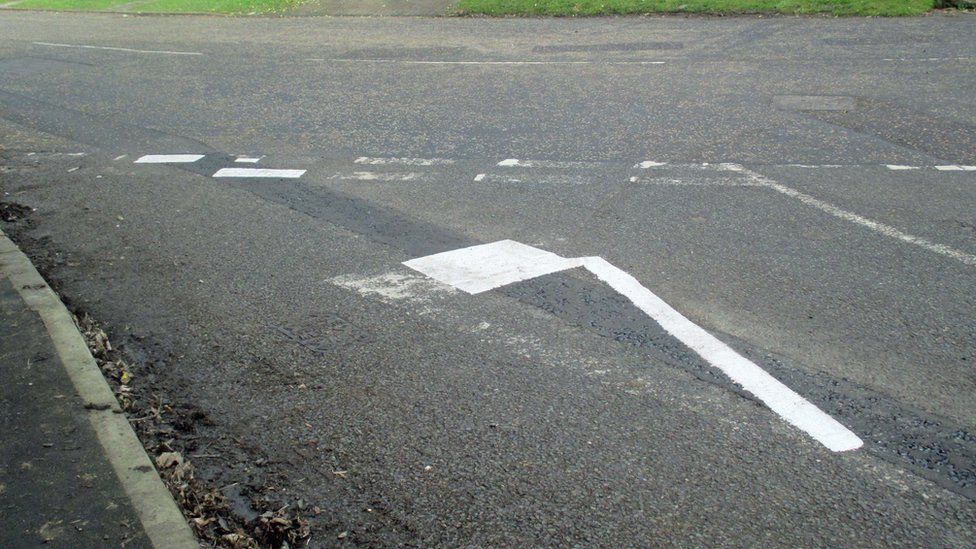 Half of word SLOW 'outside permitted area' on Boxford road - BBC News
