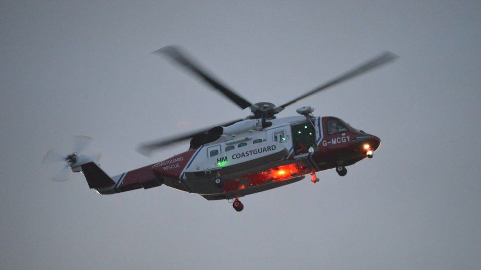 Storm Claudio: Yacht crew airlifted in 'horrendous' weather - BBC News