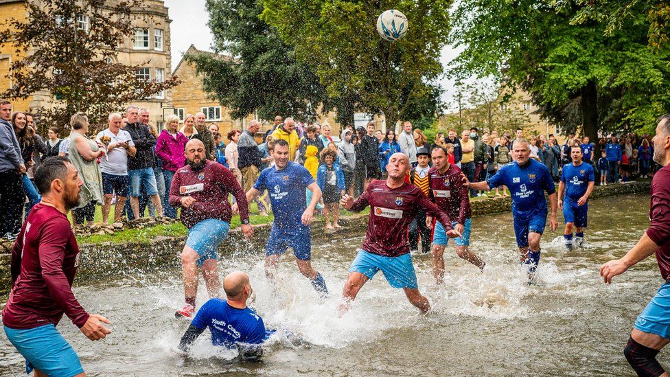 Bourton-on-the-Water crowds enjoy river football match - BBC News