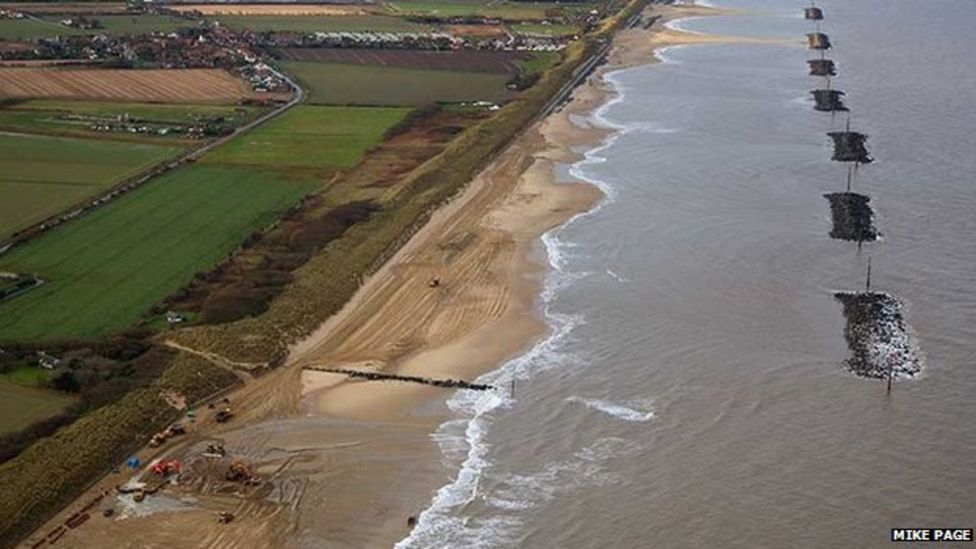 Happisburgh beach rocks moved to protect crumbling cliffs - BBC News