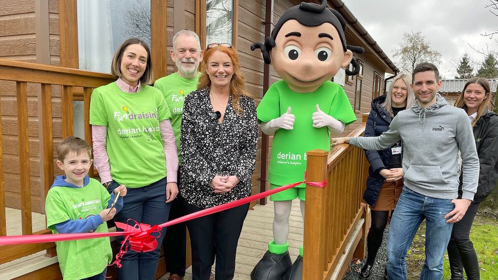 Boy opens holiday lodges as Everest challenge raises £14k - BBC News