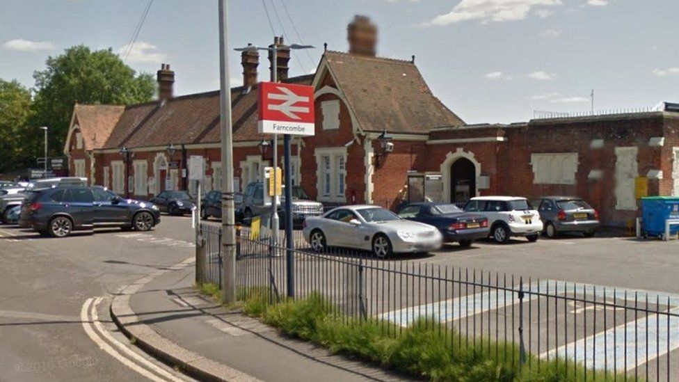 Woman charged over Farncombe station police officer attack - BBC News