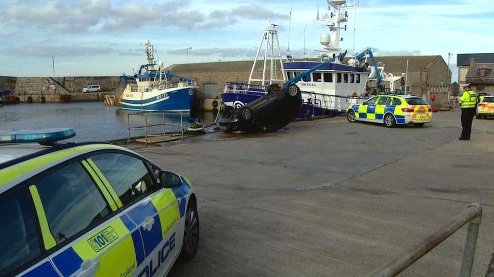 Woman rescued after Macduff car harbour plunge - BBC News
