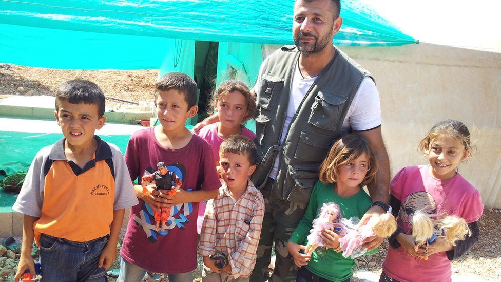 Syria war: The toy smuggler bringing bags of joy to children - BBC News