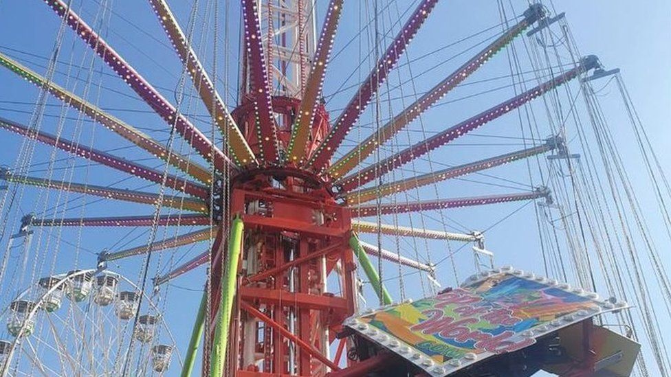 Woman badly hurt after car drives into Wigan funfair - BBC News